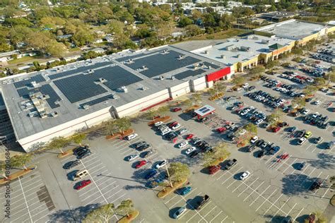 Many Parked Cars On Store Parking Lot With Lines And Markings For