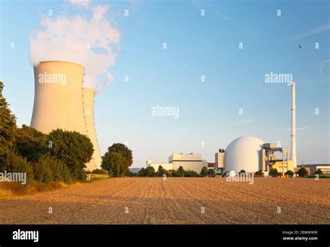 Reactor Building Smoke Stack And Two Cooling Towers Of A Nuclear Power Station An Empty Field
