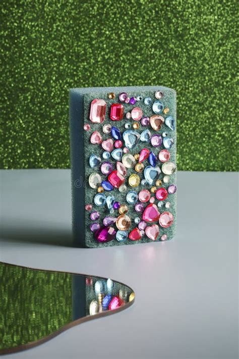 Blue Sponge In Crystals And Rhinestones On White Green Background