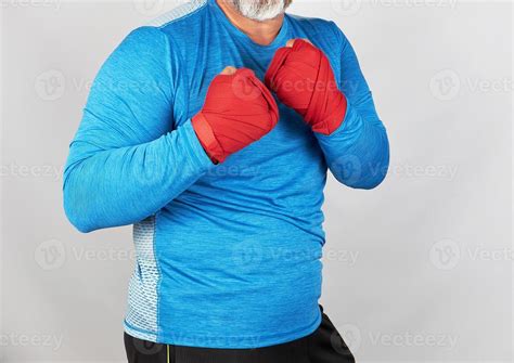 Adult Athlete In Blue Clothes Hands Wrapped In A Red Elastic Bandage