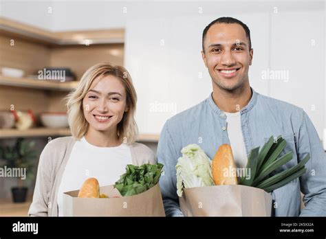 Cheerful Young Indian Man And Woman Standing Together On Kitchen
