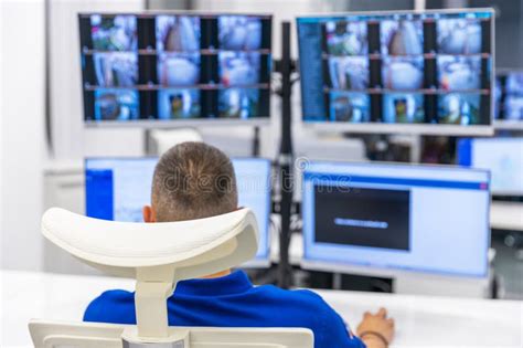 Security Officer Monitoring Multiple Surveillance Screens In A High