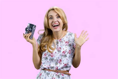Portrait Of Happy Mature Blonde Cheerful Woman Holding A Retro Photo