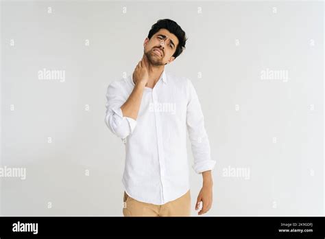 Studio Portrait Of Suffering Young Man Feeling Physical Discomfort