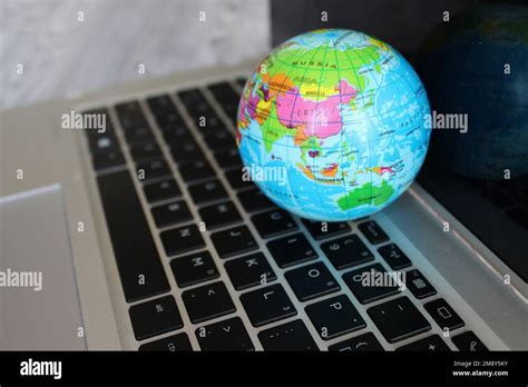 World Globe Map On Top Of Laptop Keyboard Technology And Communication Concept Stock Photo Alamy