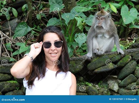 Beautiful Girl Playing With Monkey At Monkeys Forest In Bali Indonesia