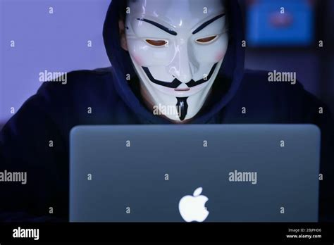 Hacker Anonymous Mask Using Laptop Hi Res Stock Photography And Images Alamy