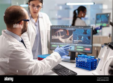Medical Team Scientist Conducting Dna Experiments Looking In Computer