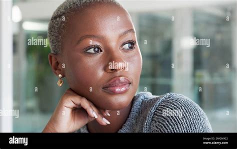 Professional Black Woman Thinking While Sitting In Her Office With