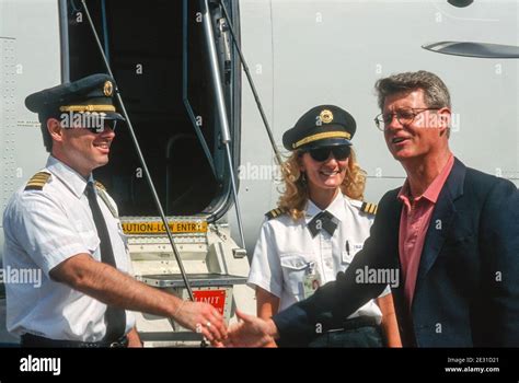 Pilot And His Female Co Pilot Greet A Passenger Outside Their Commuter Aircraft FL USA Stock
