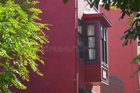 Architectural Detail Of A Red Building With A Bay Window Stock Image