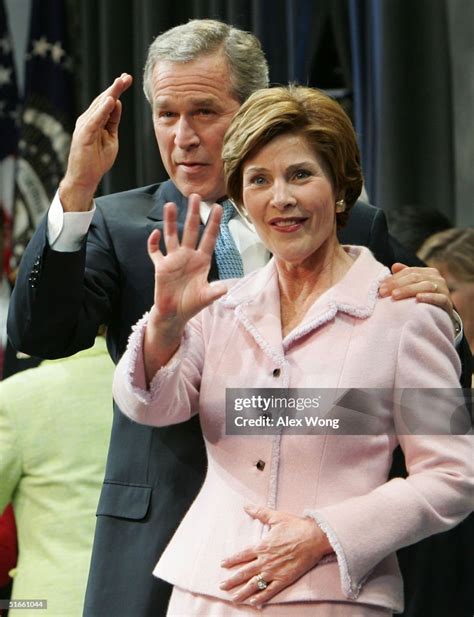 Us President George W Bush And First Lady Laura Bush Acknowledge
