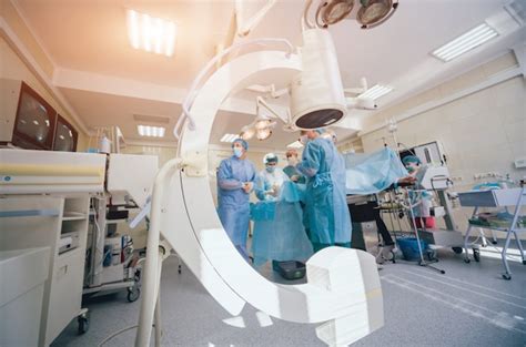 Proceso de operación de cirugía de trauma. grupo de cirujanos en quirófano con equipo de rayos x ...