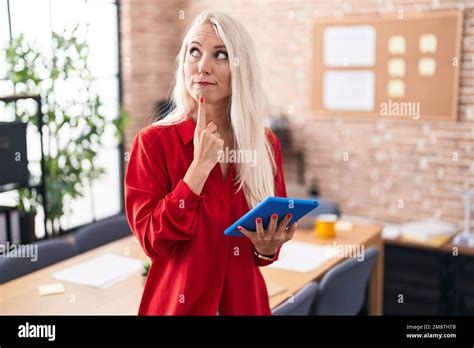 Caucasian Woman Working At The Office With Tablet Thinking Concentrated