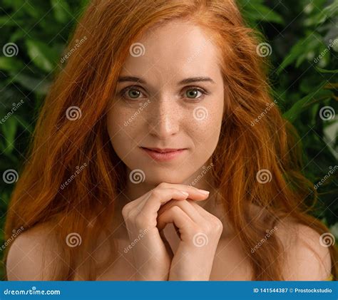 Young Redhead Girl Looking At Camera Green Leaves Background Stock