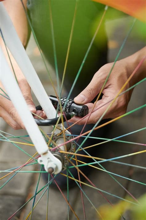 Man Putting Lock On Bicycle Wheel Stock Photo Image Of Teamwork Ride