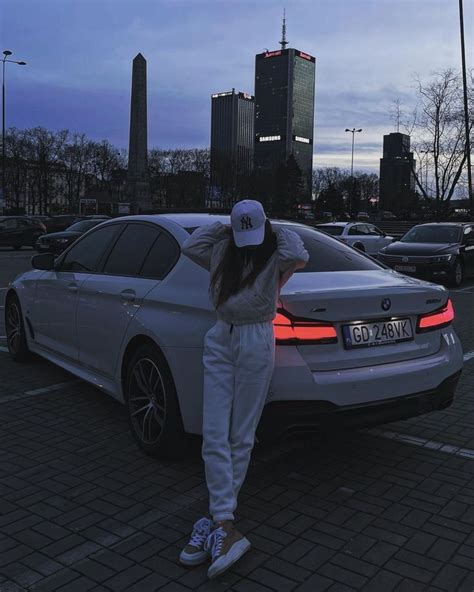 A Woman Standing Next To A Car In A Parking Lot With Her Hands On Her Head