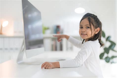 Premium Photo A Girl Using A Computer Keyboard While