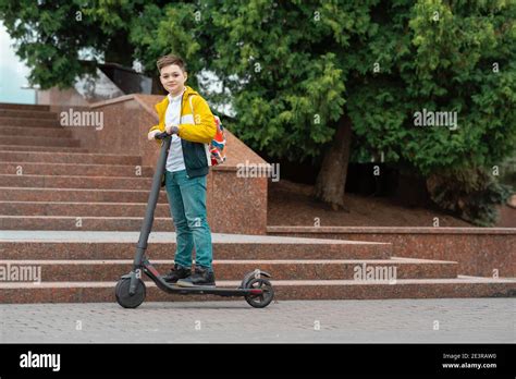 Modern teenager on electric scooter. Ecological transport concept Stock ...