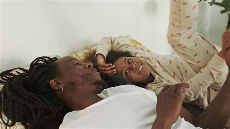 Black Father And His Daughter Talking And Bondind In Bed By Stocksy