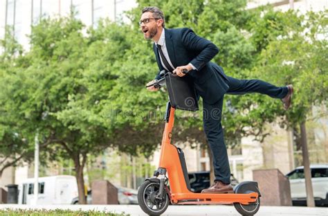 Funny Excited Business Man In A Suit Riding An Scooter On A Business