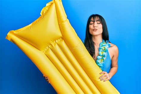 Young Brunette Woman With Bangs Wearing Swimsuit And Holding Summer