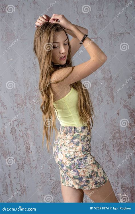 Young Long Haired Long Legged Skinny Girl In A Top Mini Skirt And