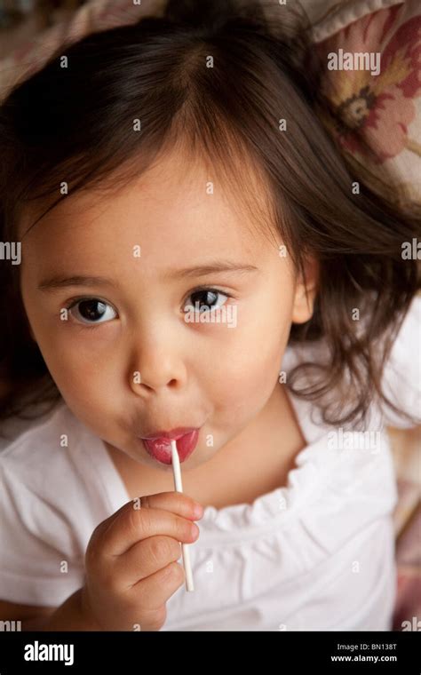 Mixed Race Asian American Caucasian Girl Portrait Sucking A Lollipop