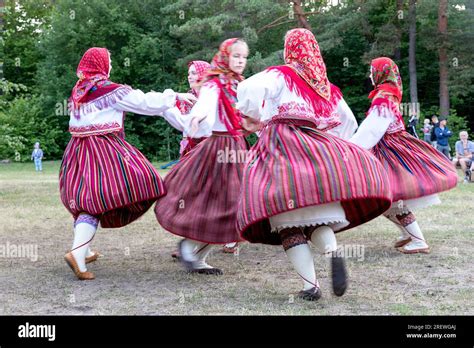 Girls In Traditional Estonian Clothing Dancing And Celebrating Estonian
