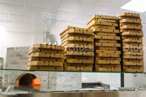 피자 상자 더미 피자 배송 및 배달을위한 골판지 갈색 상자 많은 포장이 부엌 재고에 있습니다 음식 주문 및 전달 개념 정면보기