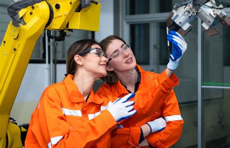 In An Electronic Parts Facility Two Female Engineers In The Plant Inspecting And Testing