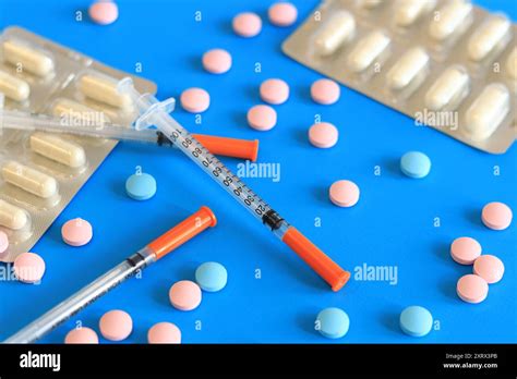 Insulin Syringes And Vitamins On A Blue Background Diabetes Treatment