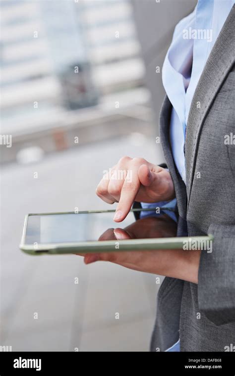 Woman Typing With Finger On Her Tablet Computer Outdoors Stock Photo Alamy