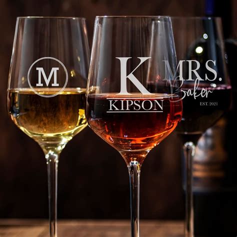 Three Wine Glasses Sitting Next To Each Other On A Table