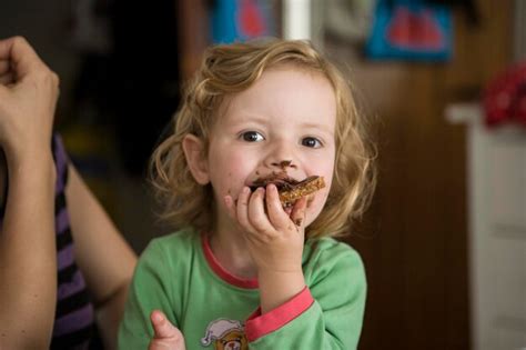 Premium Photo Cute Girl Eating Chocolate At Home