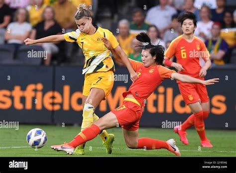 Stephanie Catley Of Australia Is Tackled By Luo Guiping Of China During