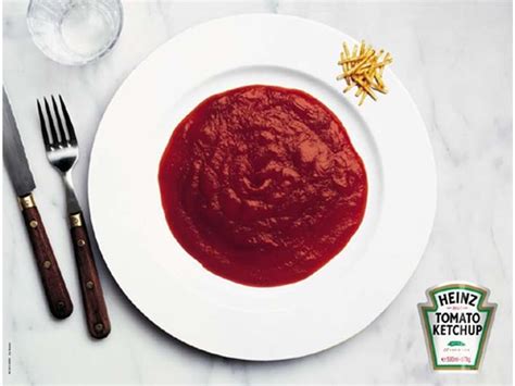 A White Plate Topped With Red Sauce Next To Silverware