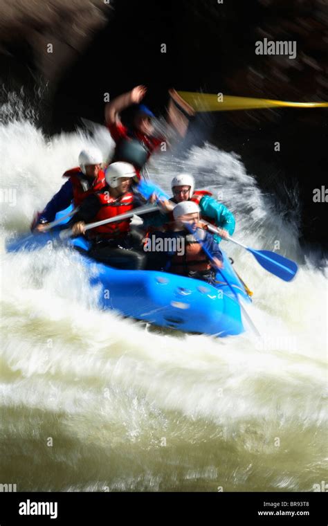 Motion Blur Photo Of Unknown Whitewater Rafters Crashing Through Pillow