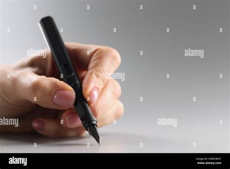 Person Holding Black Feather Pen Sharp Tip Tool For Writing Stock