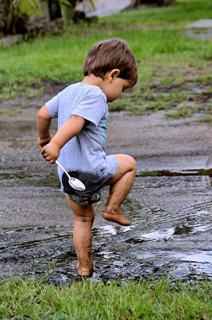 Premium Photo Full Length Of Boy Playing In Mud