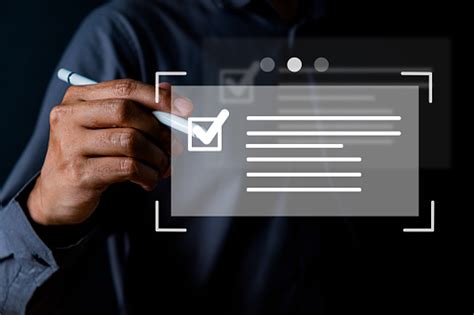 Businessman Uses A Pen To Mark Checkboxes For Quality Document Control