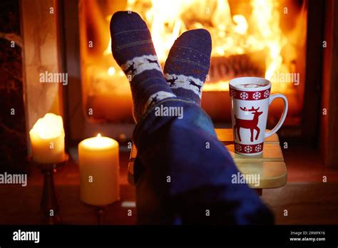 Mans Feet In Warm Socks With Large Mug Of Hot Chocolate And