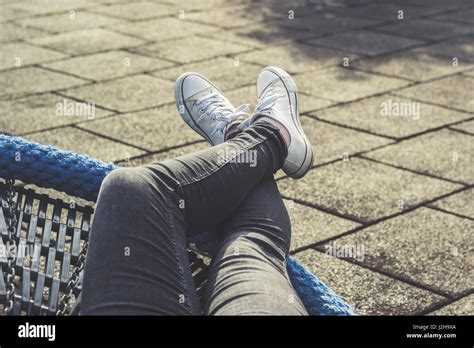 Woman Relaxing Outdoors Lying Legs Crossed Wearing Black Jeans And