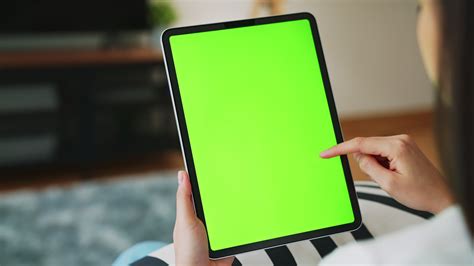 Woman Holding A Tablet With Green Screen 2215890 Stock Video At Vecteezy