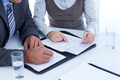 Premium Photo Businessman With Secretary Checking File