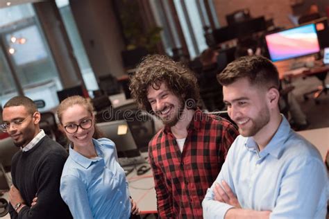 A Team Of Successful Programmers Sits In A Startup Office Strategizing New Business Projects