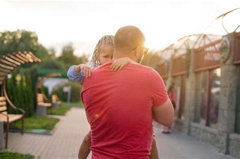 Premium Photo The Father Comforts The Little Crying Daughter Holding