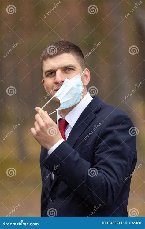 Masked Businessman Portrait Of A Man In A Protective Medical Mask