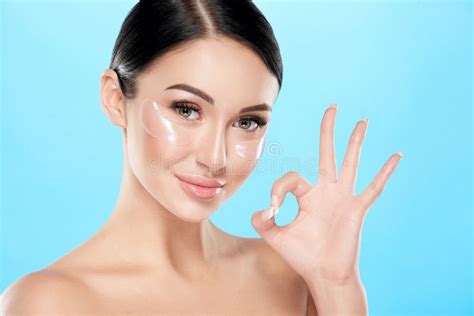Young Girl With Nude Make Up And Naked Shoulders At Studio Background