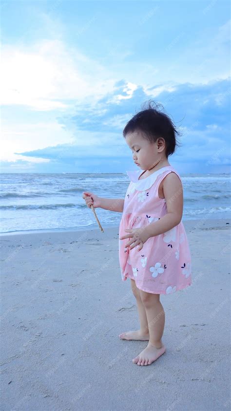 Premium Photo Side View Of Cute Girl Standing At Beach